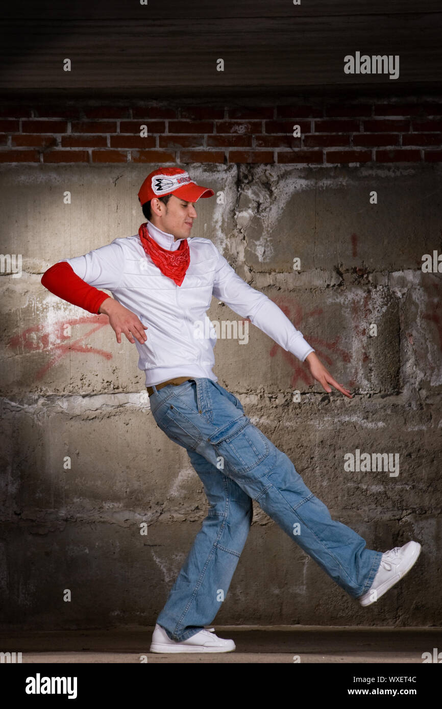 Hip hop men dancing in modern style over grey brick wall Stock Photo ...