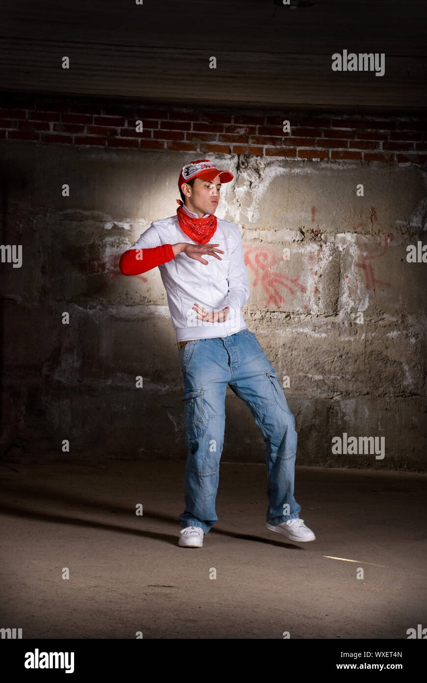 Hip hop men dancing in modern style over grey brick wall Stock Photo ...
