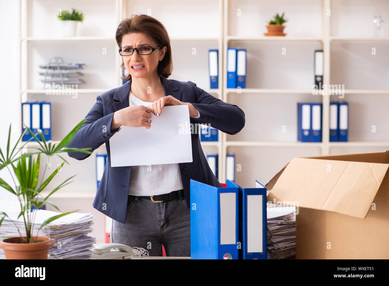 Middle-aged female employee being fired from her work Stock Photo - Alamy