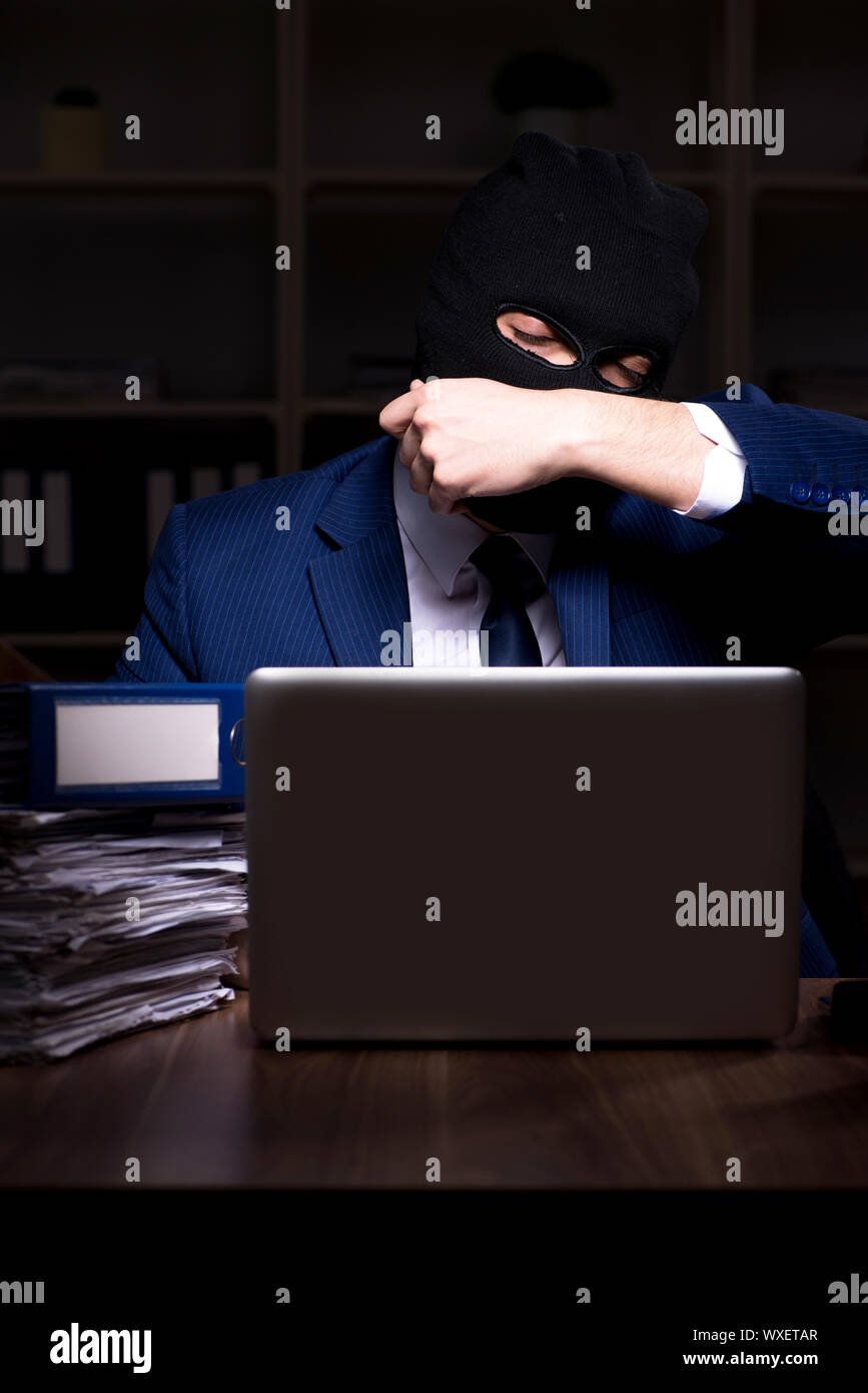 Male employee stealing information in the office night time Stock Photo ...