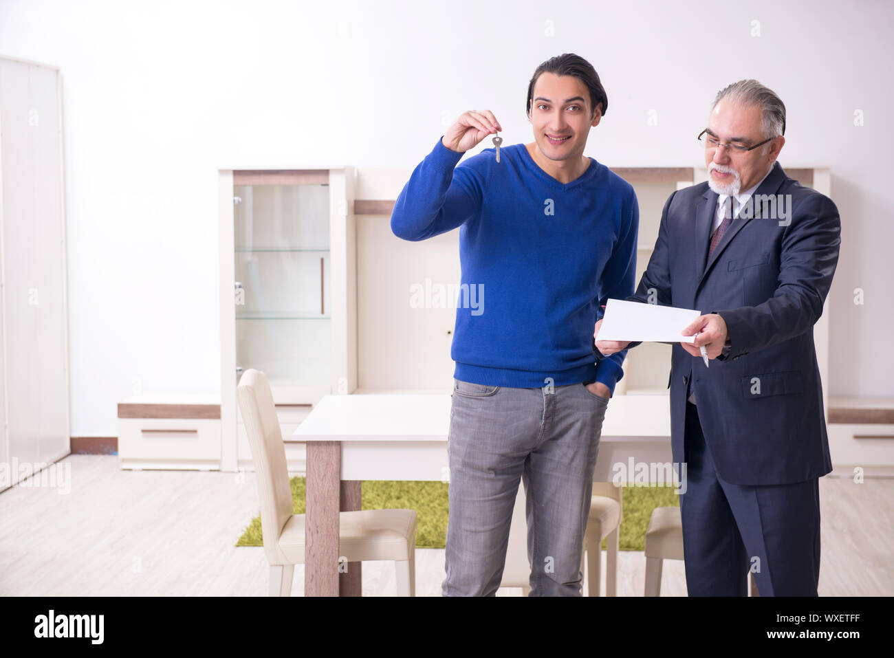 Male real estate agent and male client in the apartment Stock Photo - Alamy