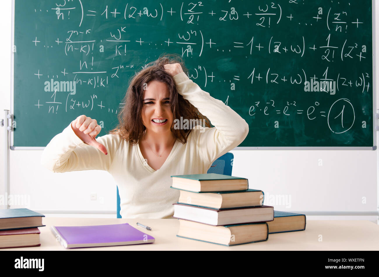 Young female math teacher in front of chalkboard Stock Photo - Alamy
