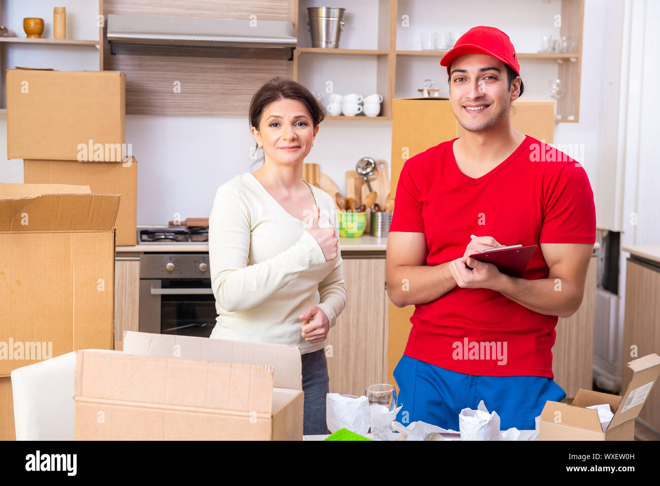 Young male contractor and female customer in moving concept Stock Photo ...