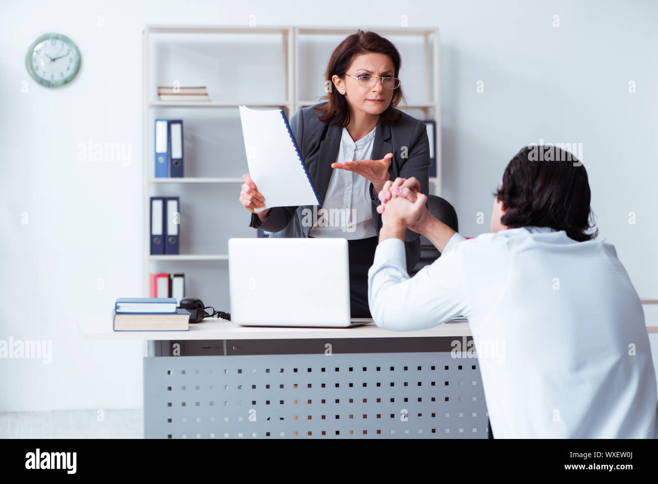Old female boss and young male employee in the off hi-res stock ...