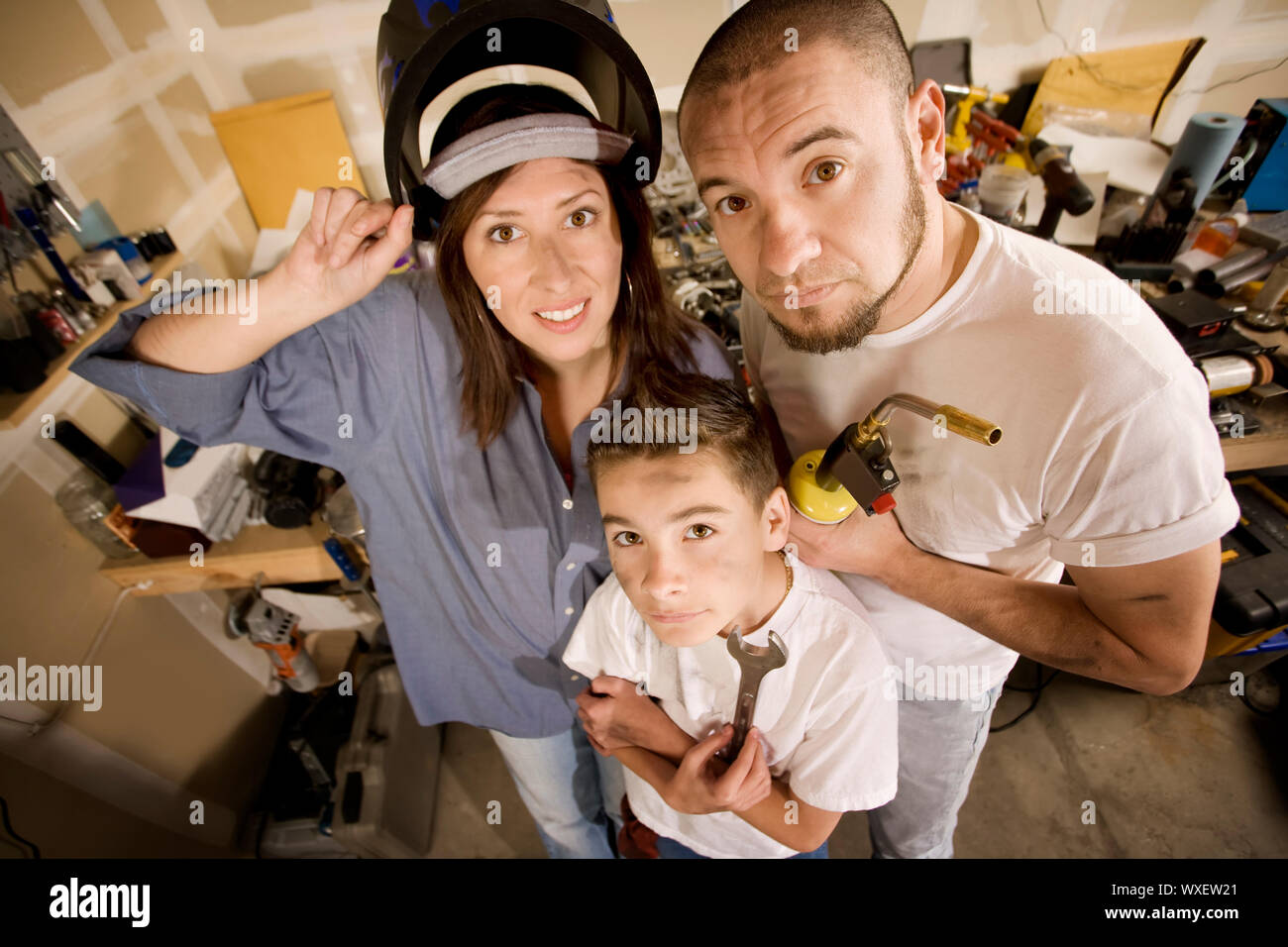 Funny Hispanic family in garage with variety of tools Stock Photo - Alamy