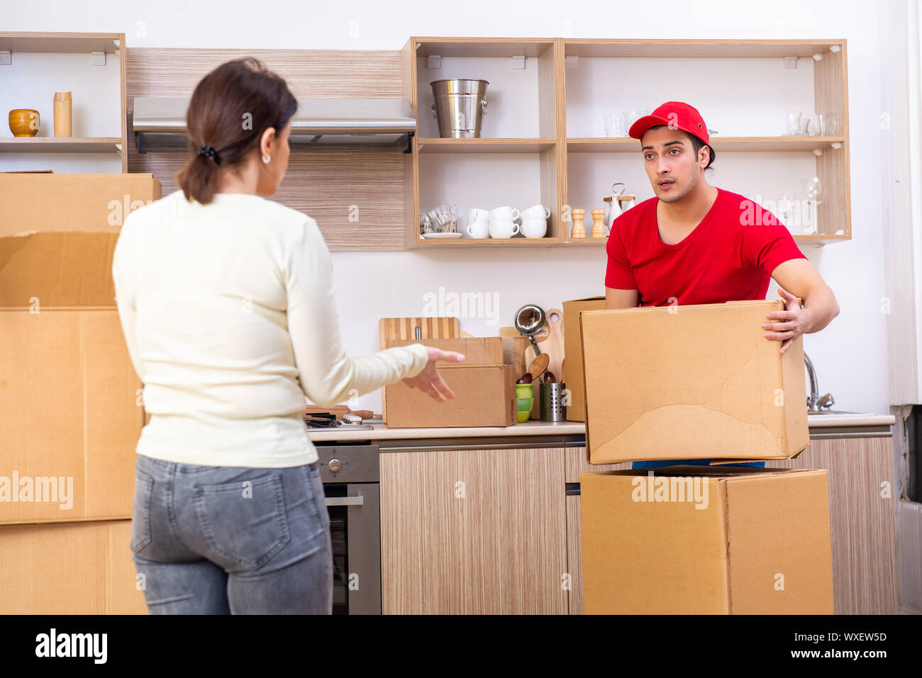 Young male contractor and female customer in moving concept Stock Photo ...