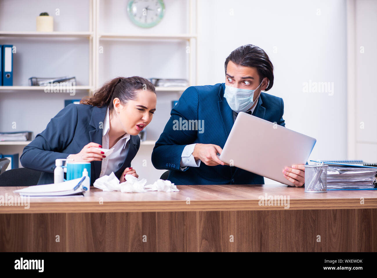 Two employees suffering at workplace Stock Photo - Alamy