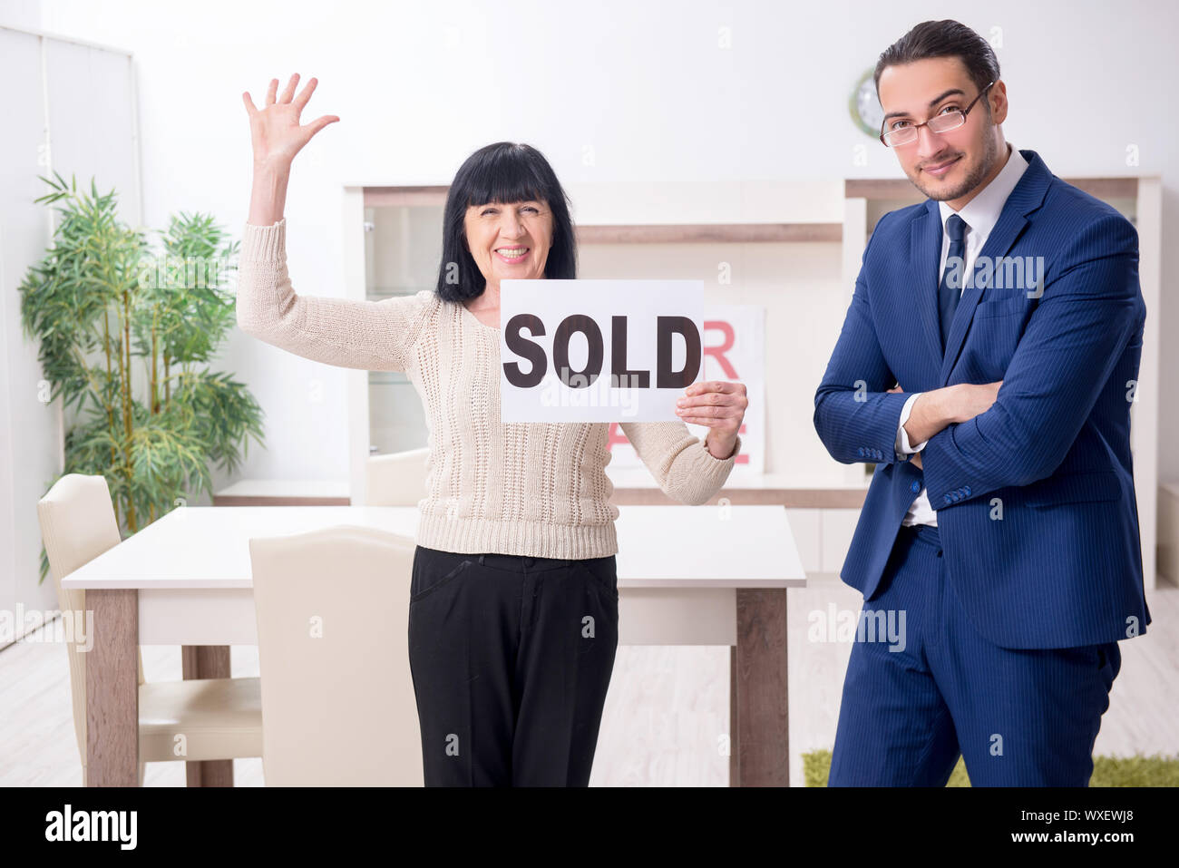 Male real estate agent and female client in the apartment Stock Photo ...