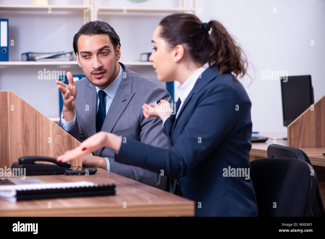 Two employees working in the office Stock Photo - Alamy