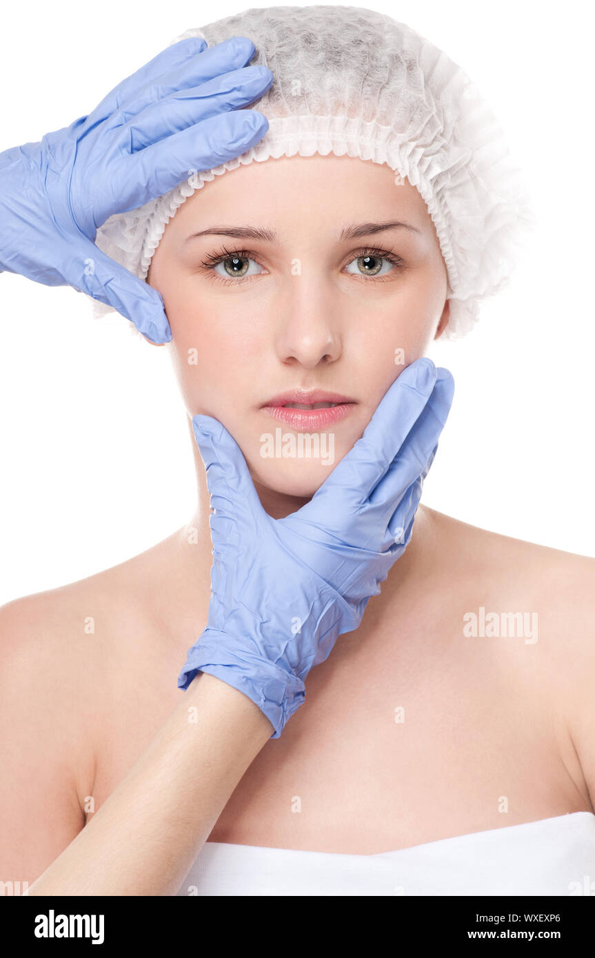 Medical face examination of beautiful woman by hands in glove - close ...