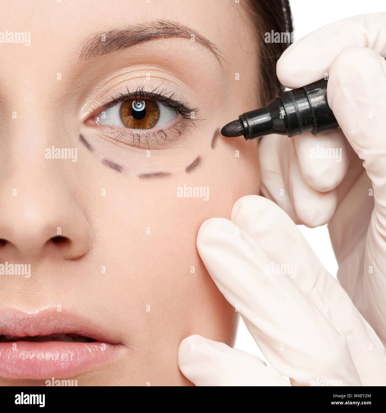 Beautician touch and draw correction lines on woman face. Before ...