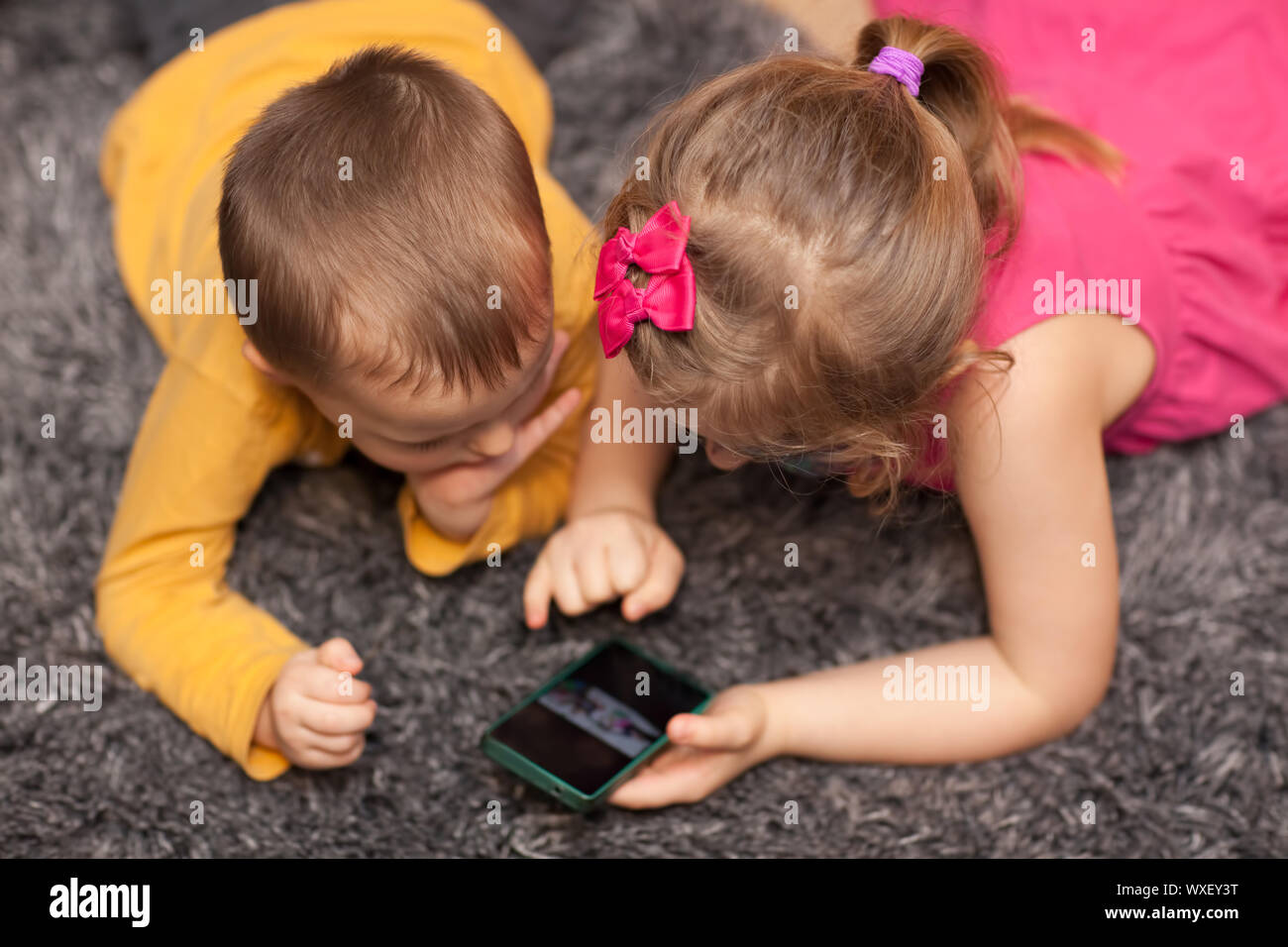 Children watching cartoons on a smartphone Stock Photo - Alamy