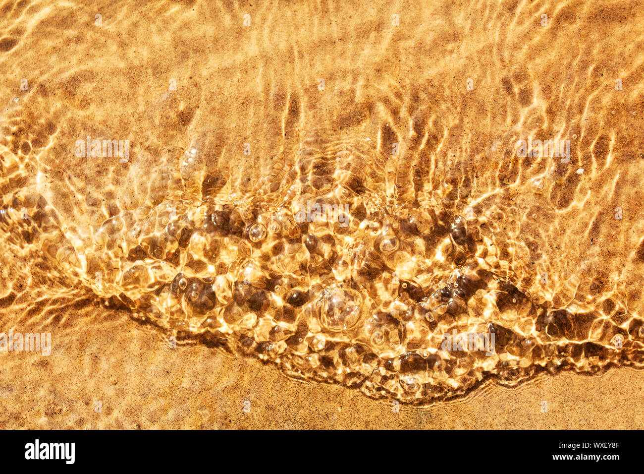 Top view of the sand texture under the sea water on the beach. Nature ...