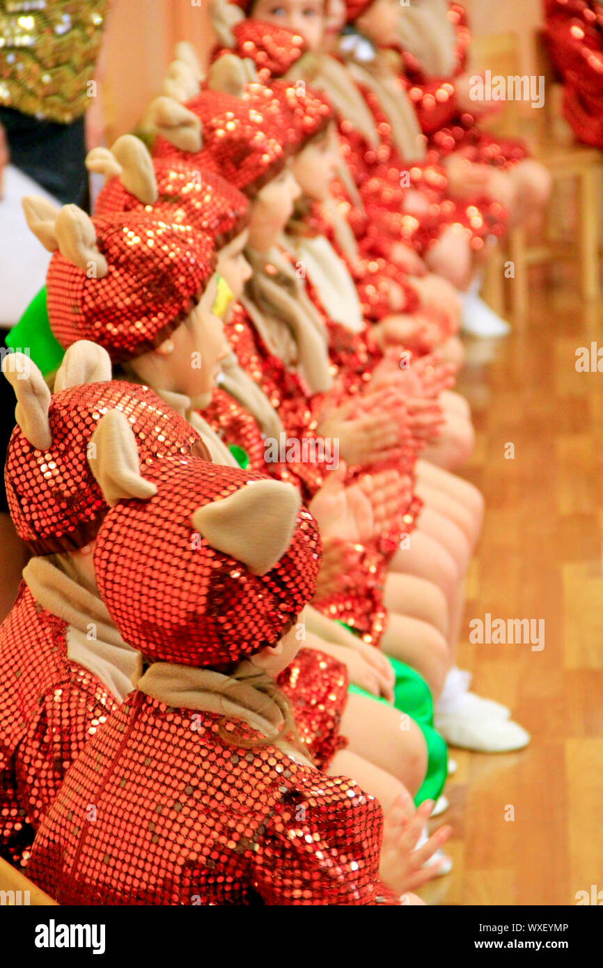 Children in fancy dresses on matinee at kindergarten. Children in smart ...