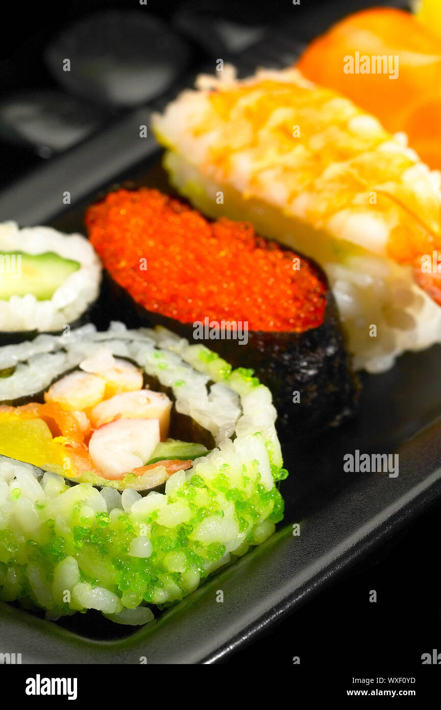 fresh assorted colorfull sushi plate over black Stock Photo - Alamy