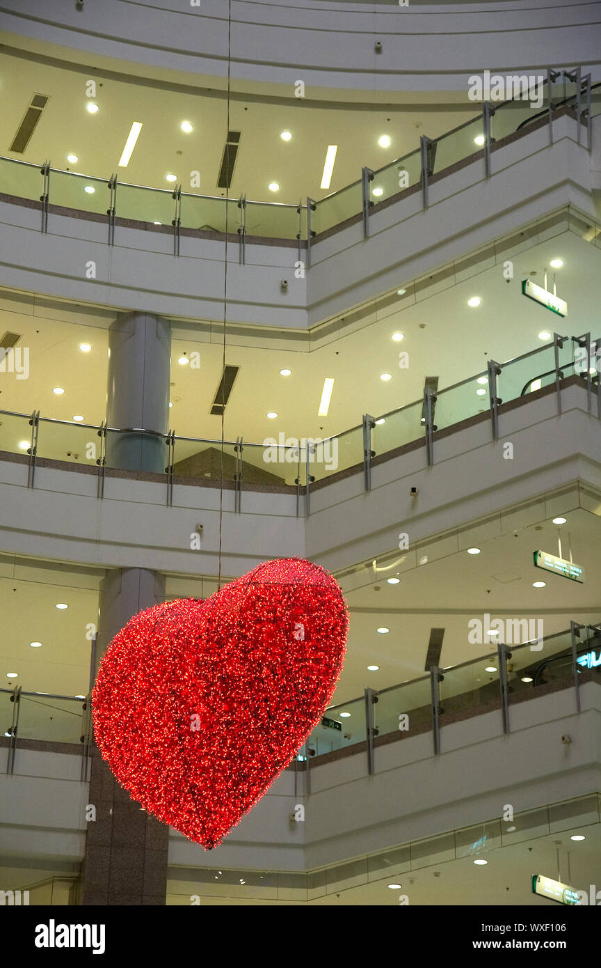 heart shaped light hanging on a shopping mall ceiling Stock Photo - Alamy