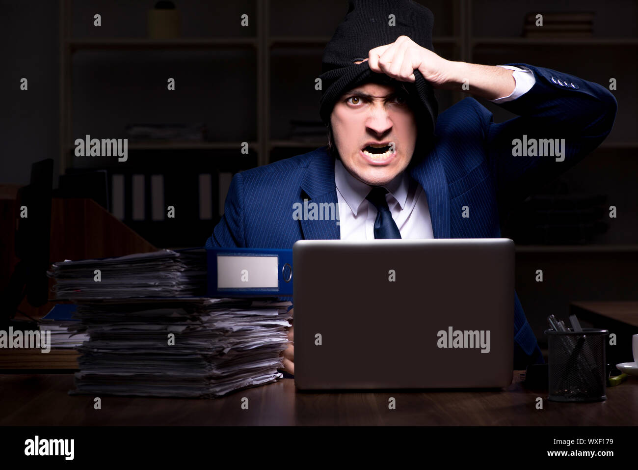 Male employee stealing information in the office night time Stock Photo ...