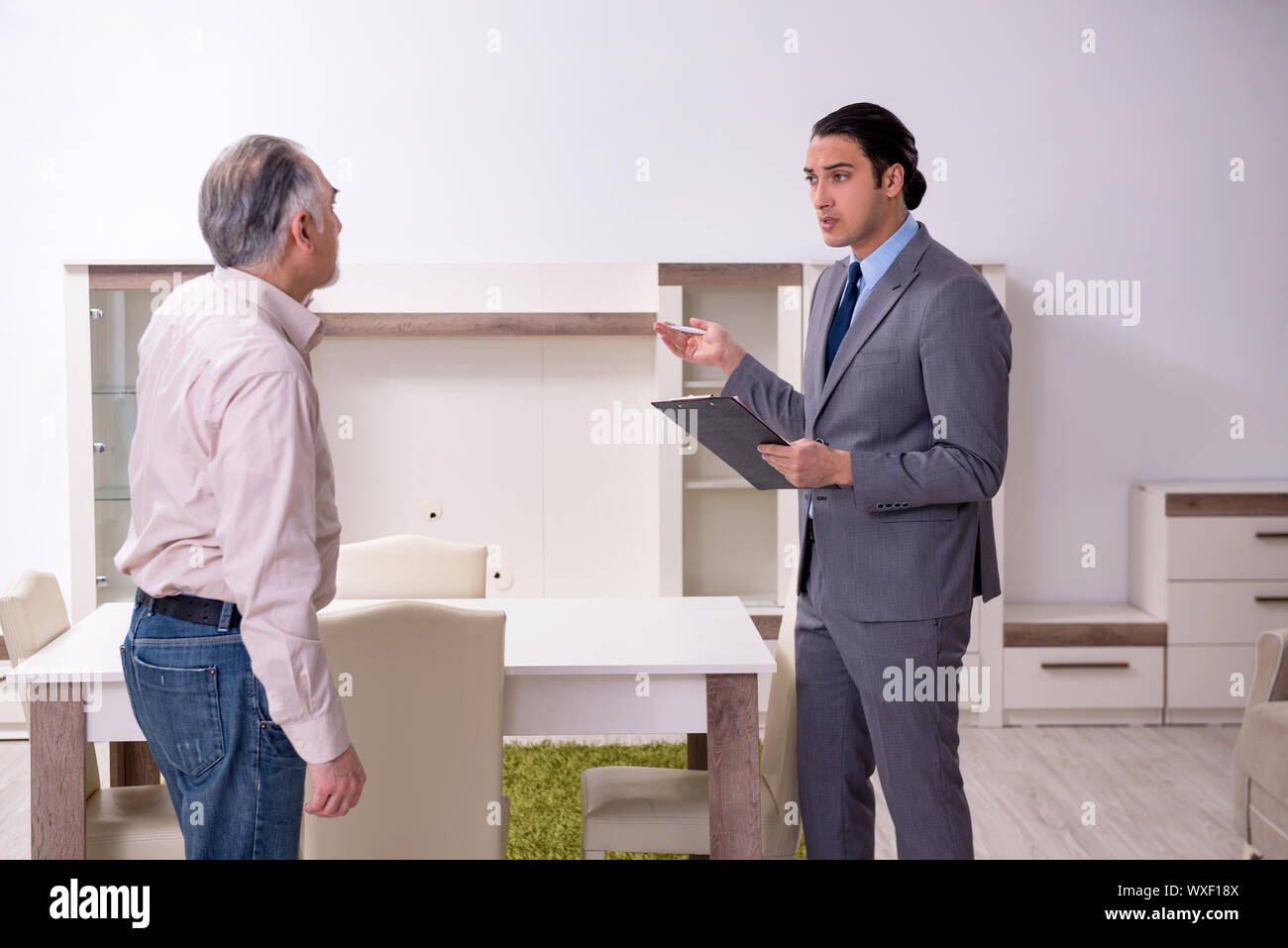 Male real estate agent and male client in the apartment Stock Photo - Alamy