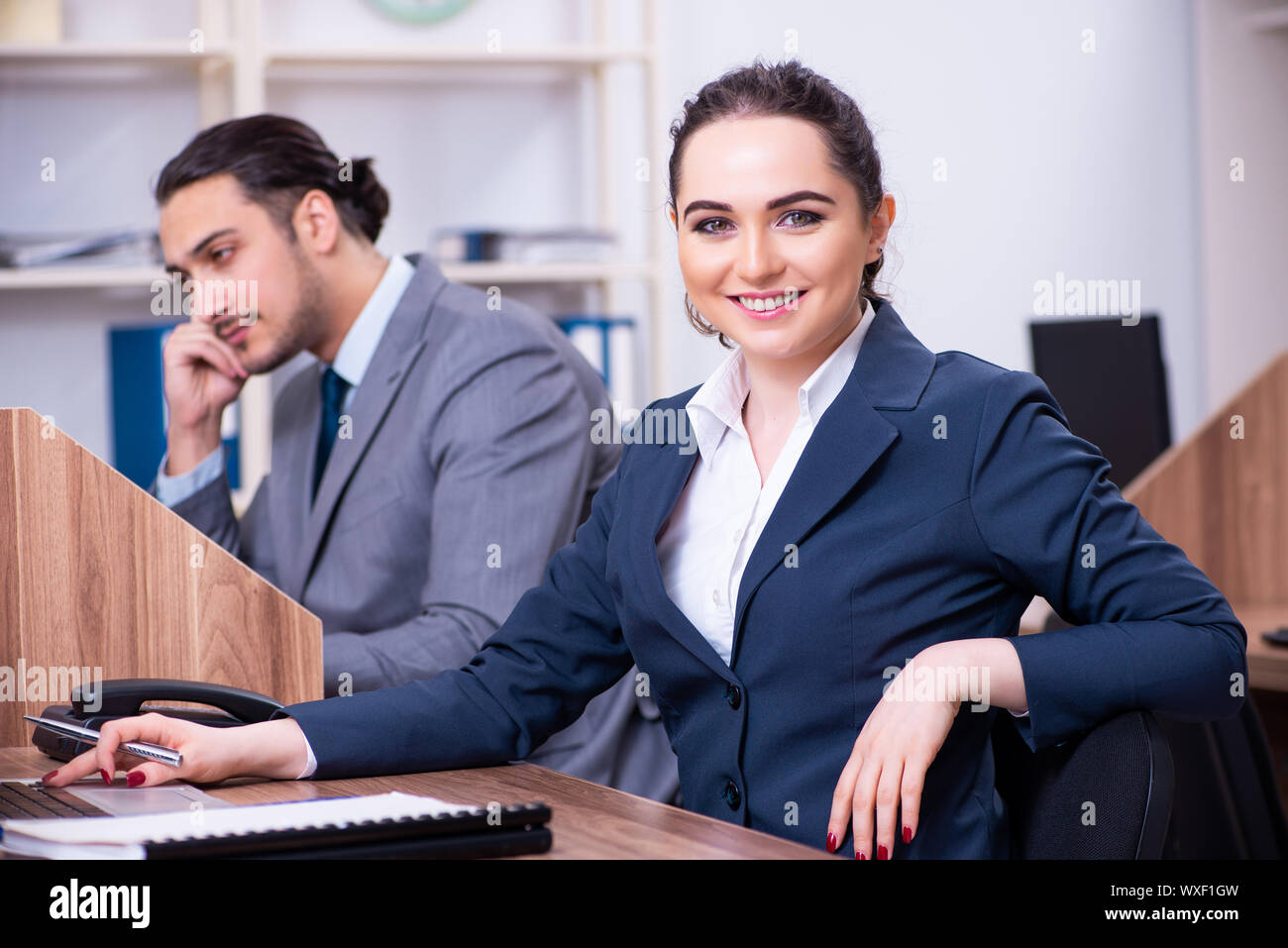 Two employees working in the office Stock Photo - Alamy