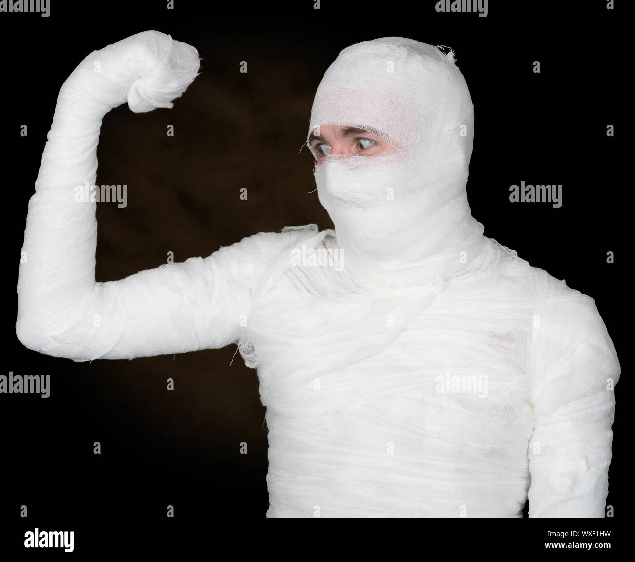 Funny mummy - athlete on the black background Stock Photo - Alamy