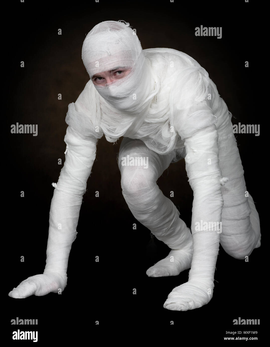 The guy in bandage on a black background Stock Photo - Alamy