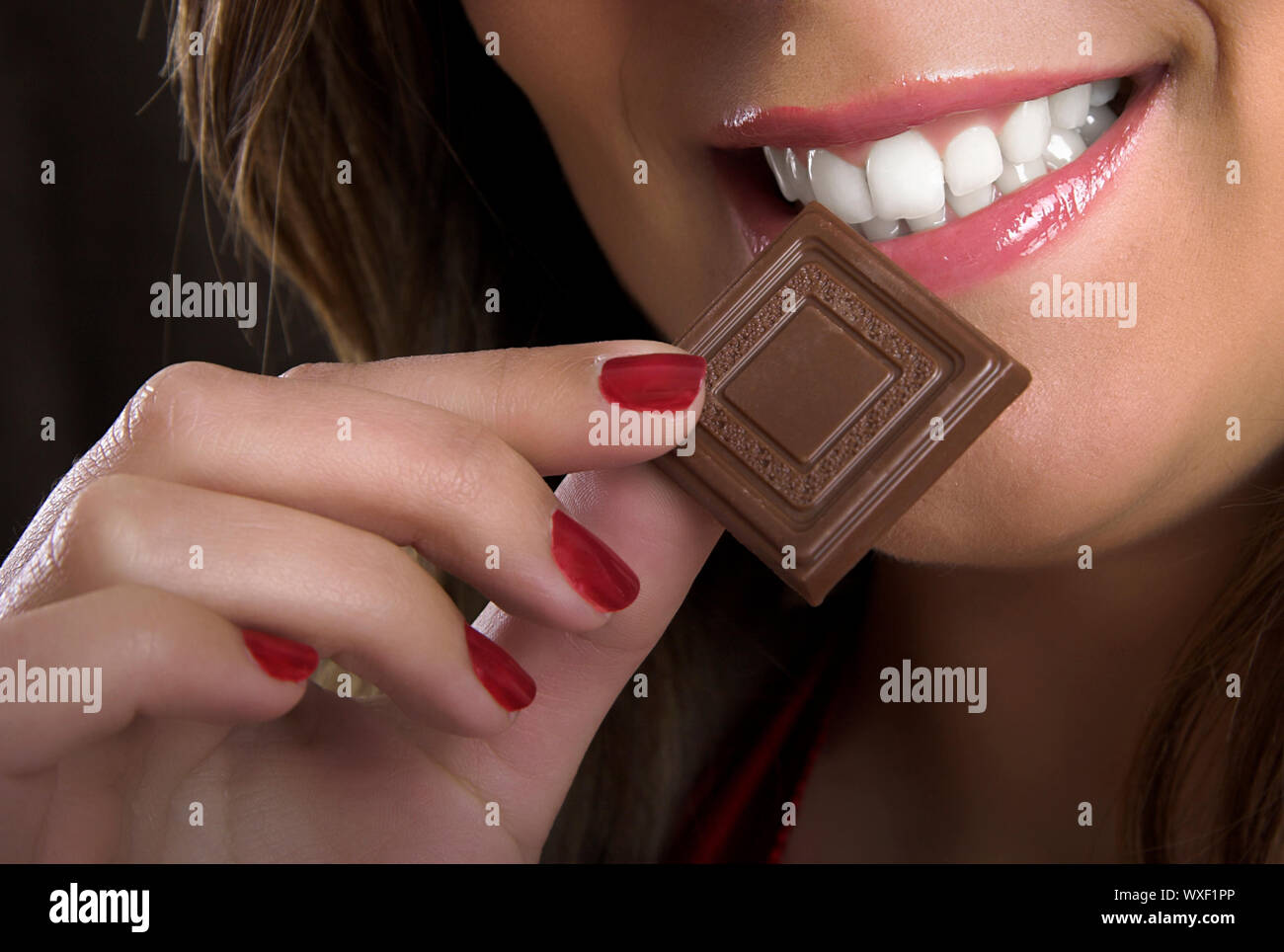 Woman eating dark chocolate mouth hi-res stock photography and images ...