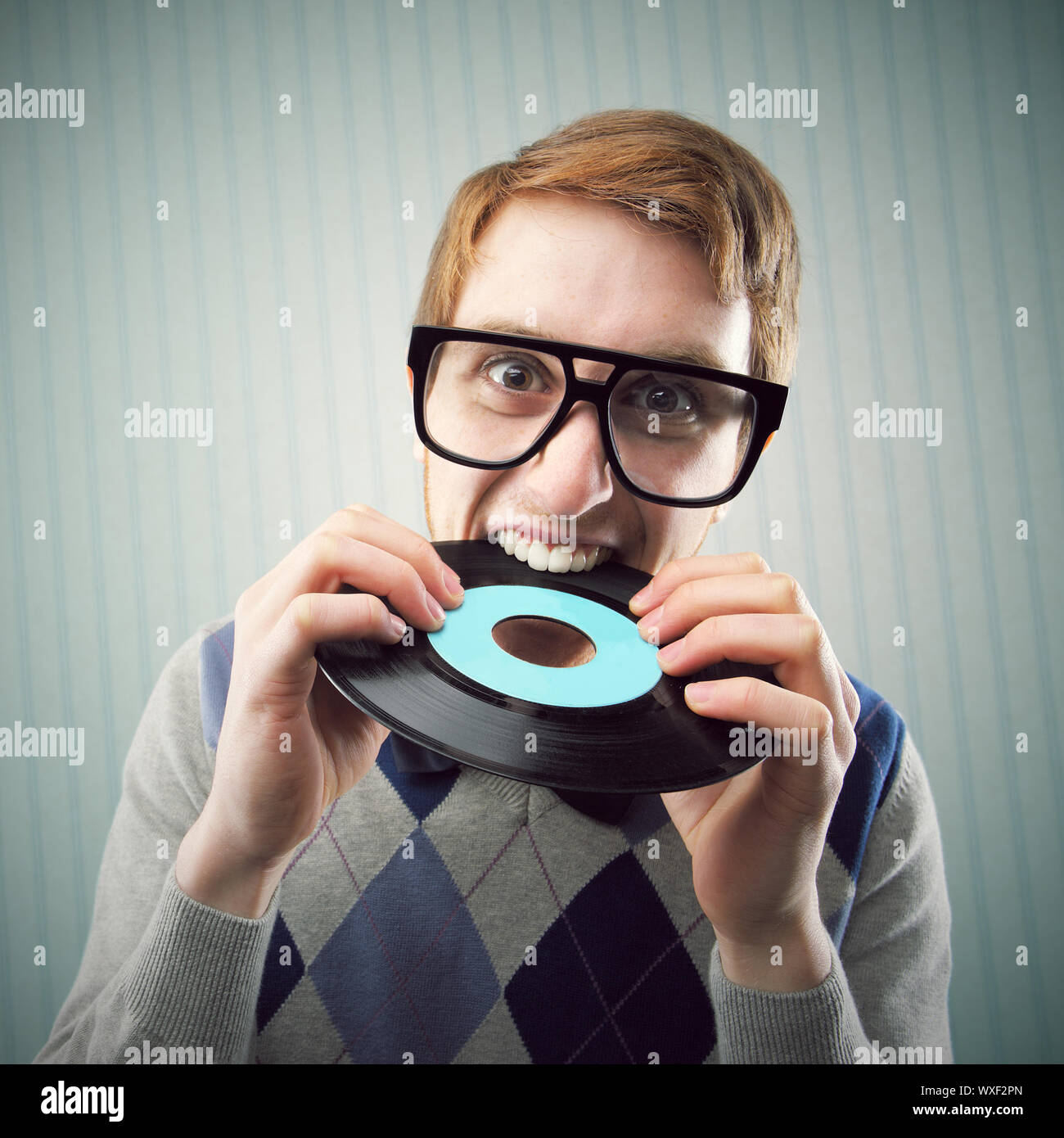 Nerd student angry, biting a vinyl record Stock Photo - Alamy