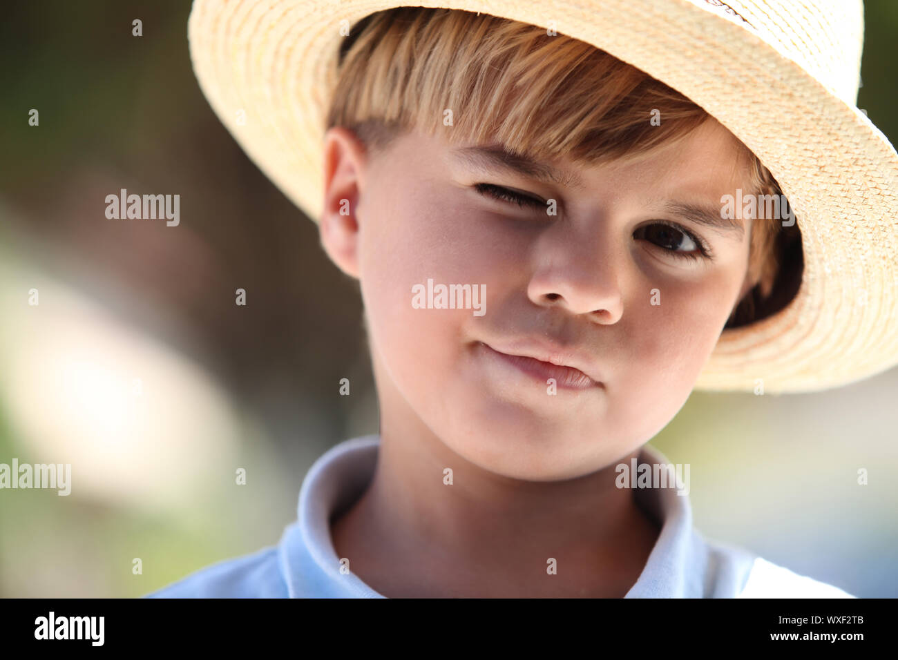 Closeup of a young boy in a straw hat Stock Photo - Alamy