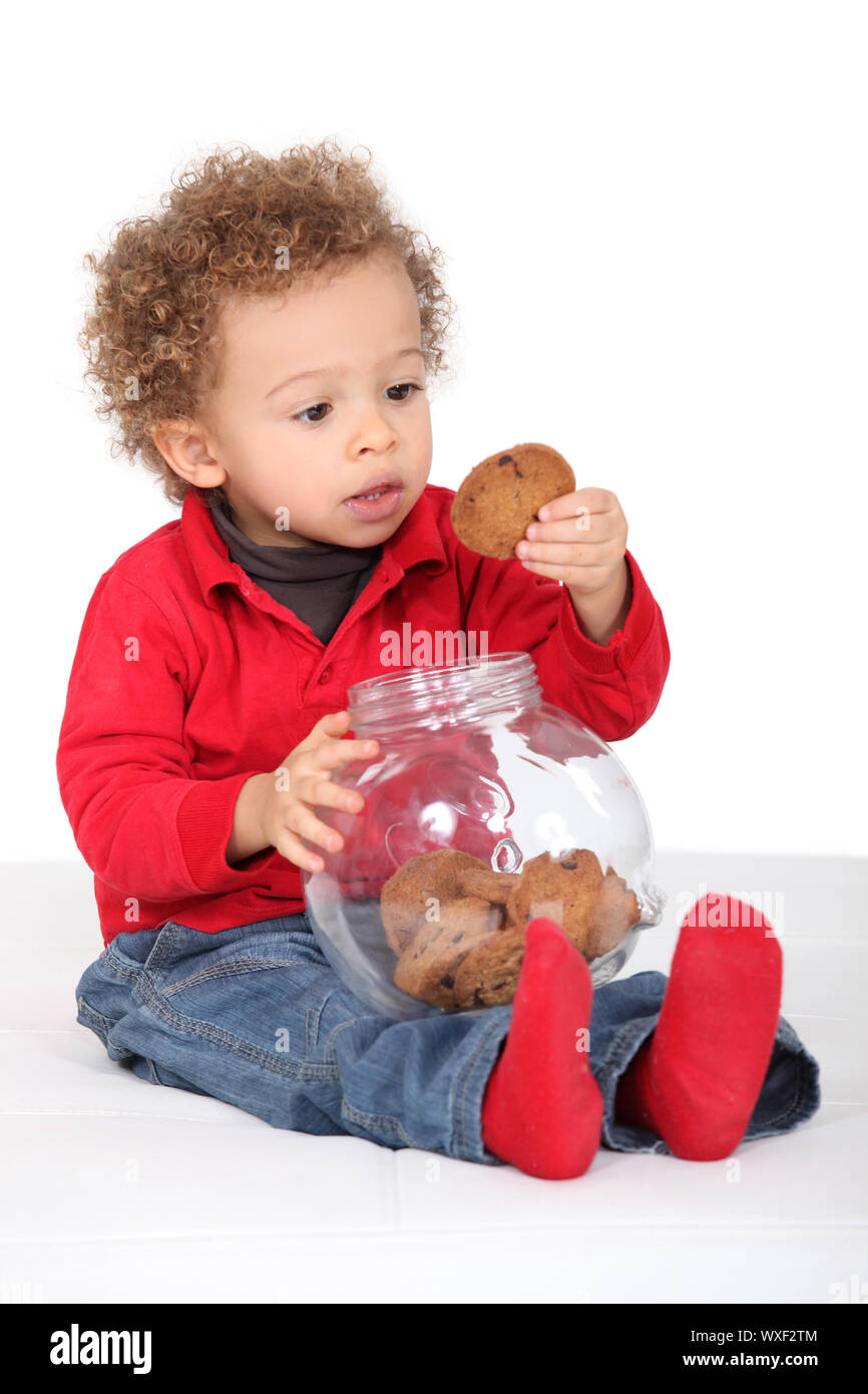 little boy eating biscuit Stock Photo - Alamy