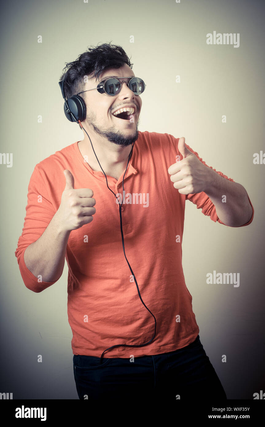 Stylish man listening to music on vignetting background Stock Photo - Alamy