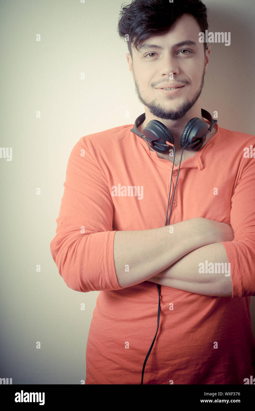 Stylish man listening to music on vignetting background Stock Photo - Alamy