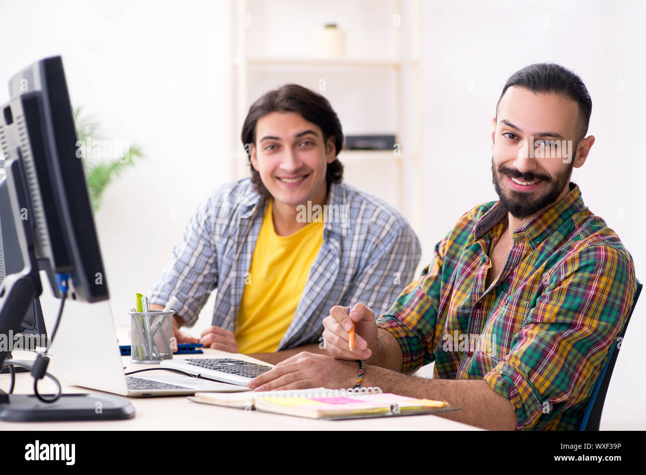 Two it specialists working in the office Stock Photo - Alamy