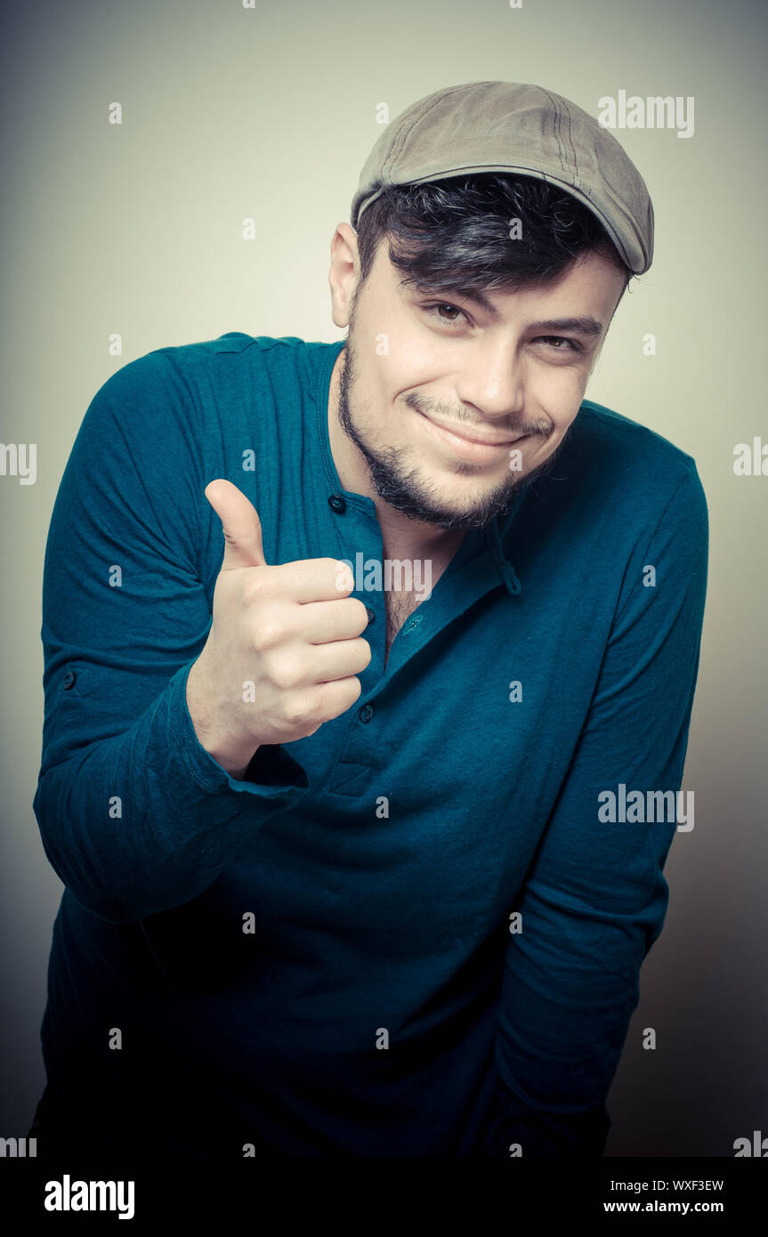 young modern stylish man with cap on vignetting background Stock Photo ...