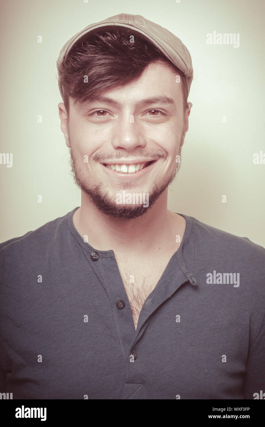 young modern stylish man with cap on vignetting background Stock Photo ...