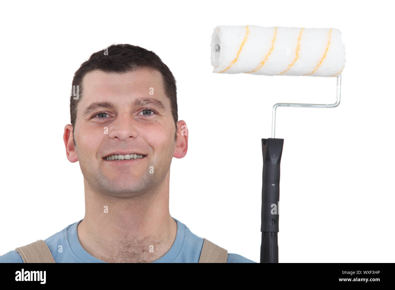 Decorator using roller to paint Stock Photo - Alamy