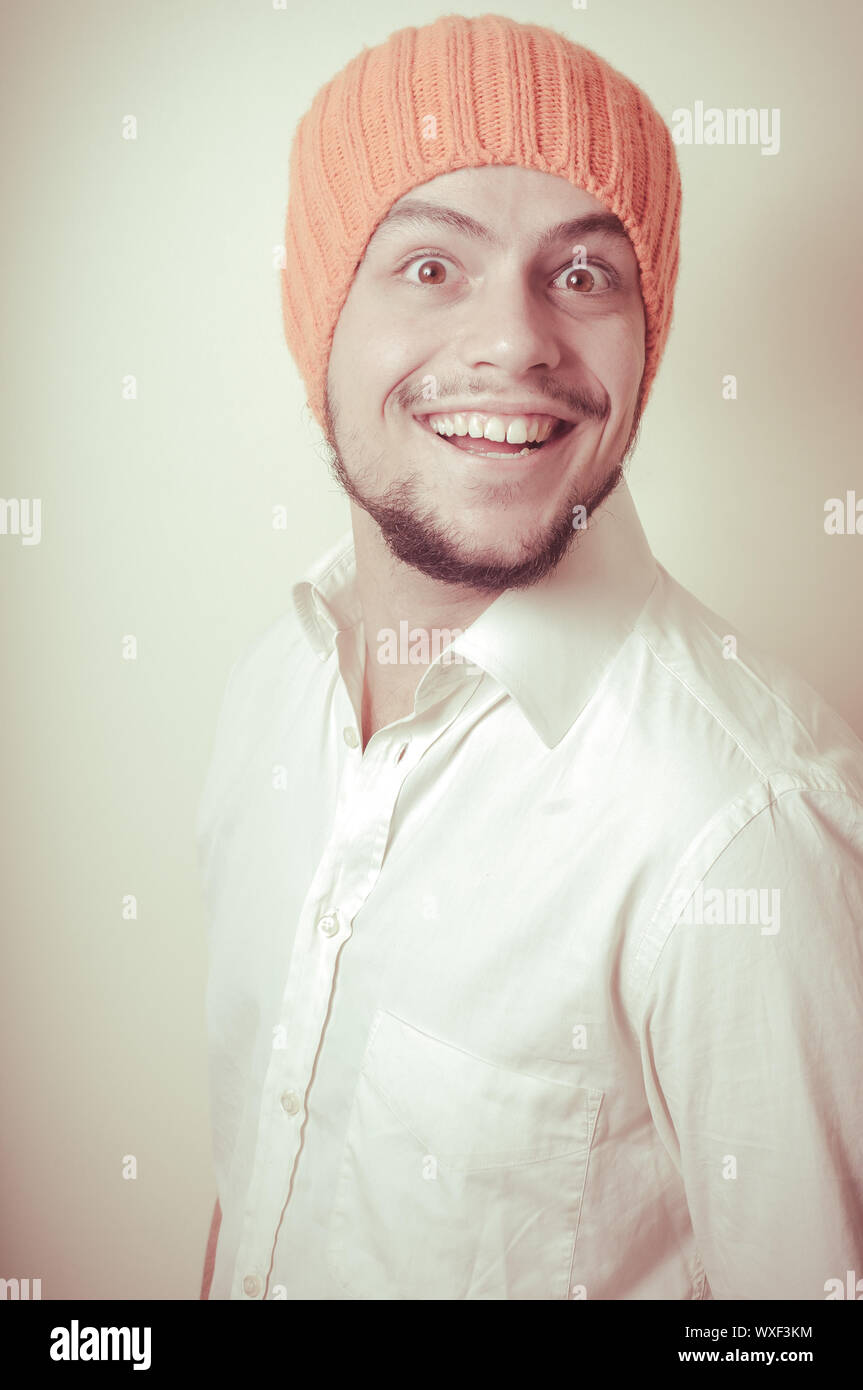 young modern stylish man with orange cap on vignetting background Stock ...