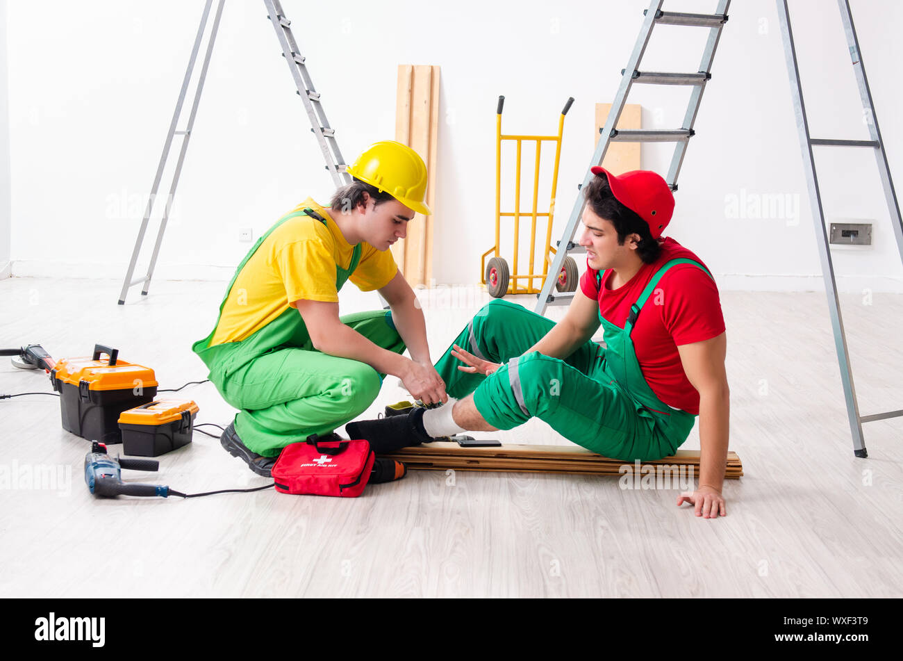 Injured worker and his workmate Stock Photo - Alamy