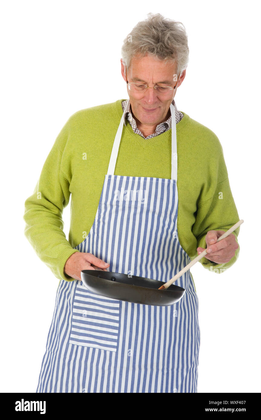 Elderly man is cooking in the kitchen Stock Photo - Alamy