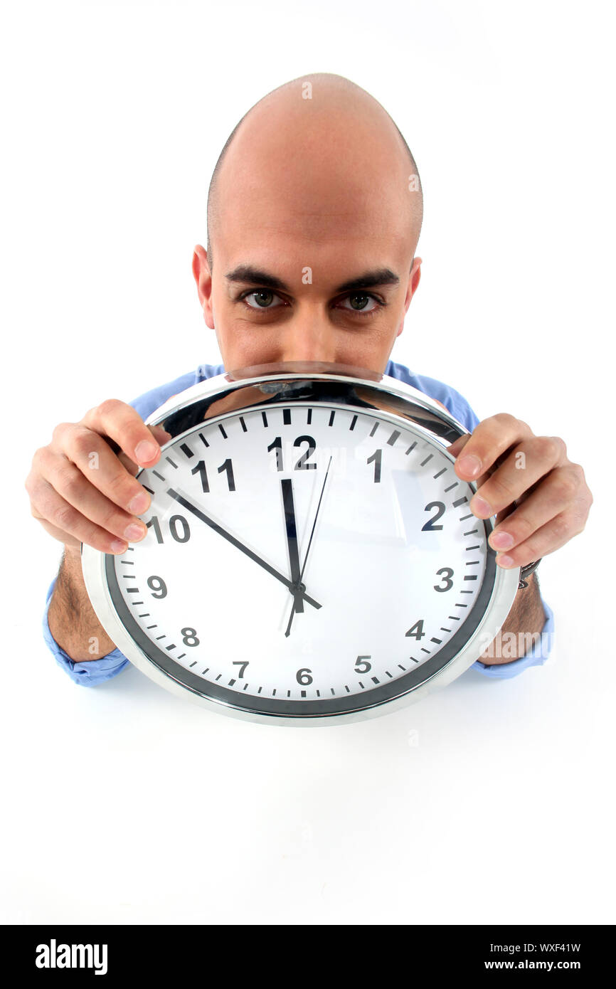 Bald man showing a clock Stock Photo - Alamy