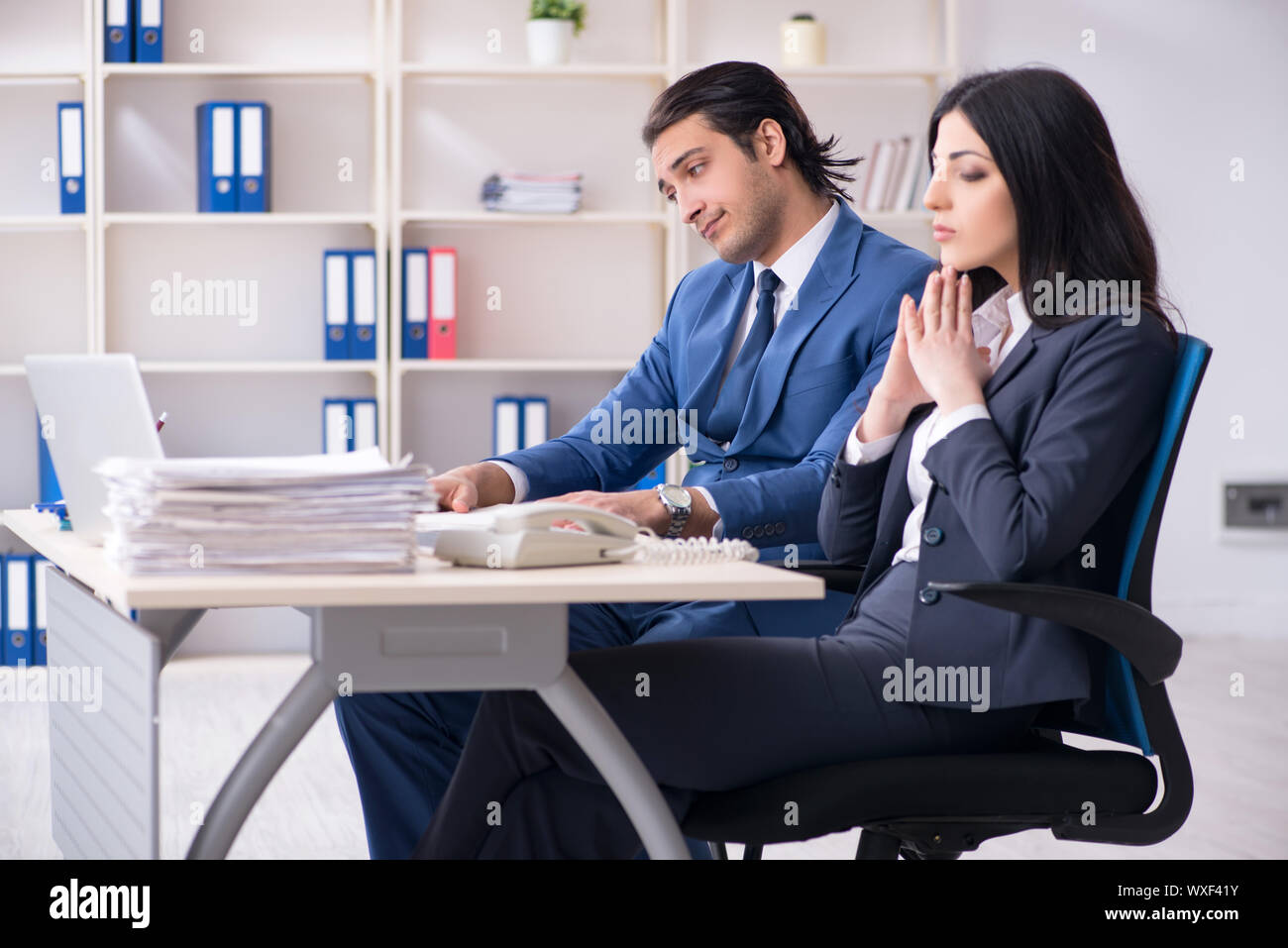 Two employees working in the office Stock Photo - Alamy