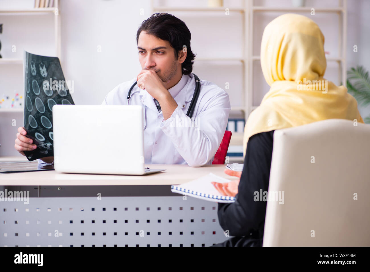 Female arab patient visiting male doctor Stock Photo - Alamy