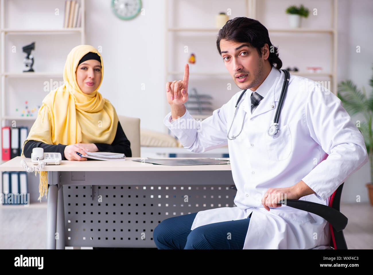 Female arab patient visiting male doctor Stock Photo - Alamy