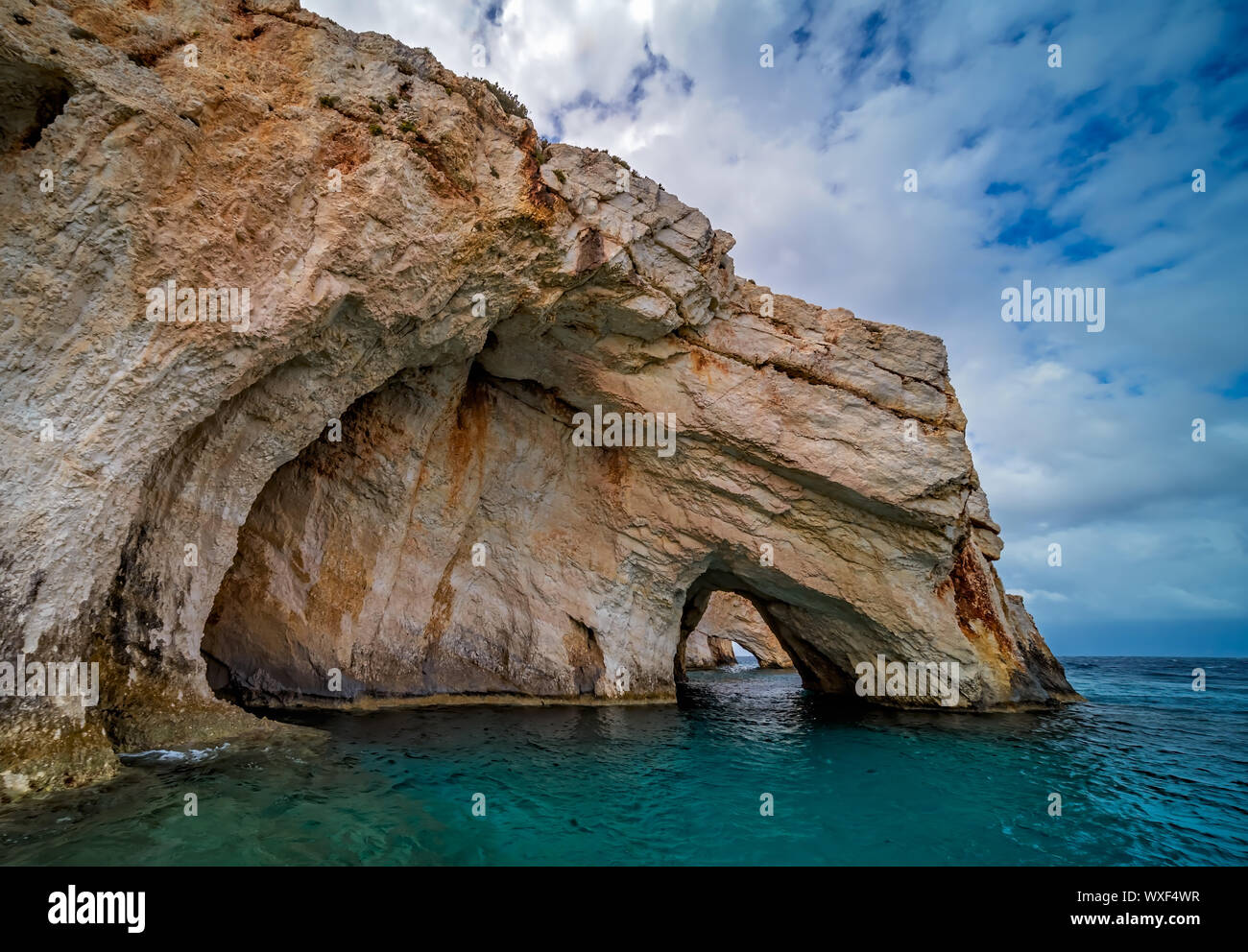 Stone arch entrance to one of Blue Caves Stock Photo - Alamy