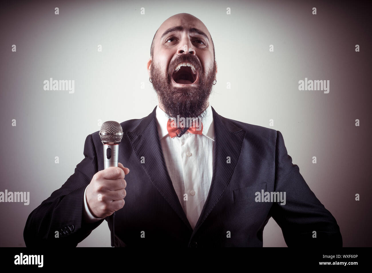funny elegant singer bearded on vignetting background Stock Photo - Alamy