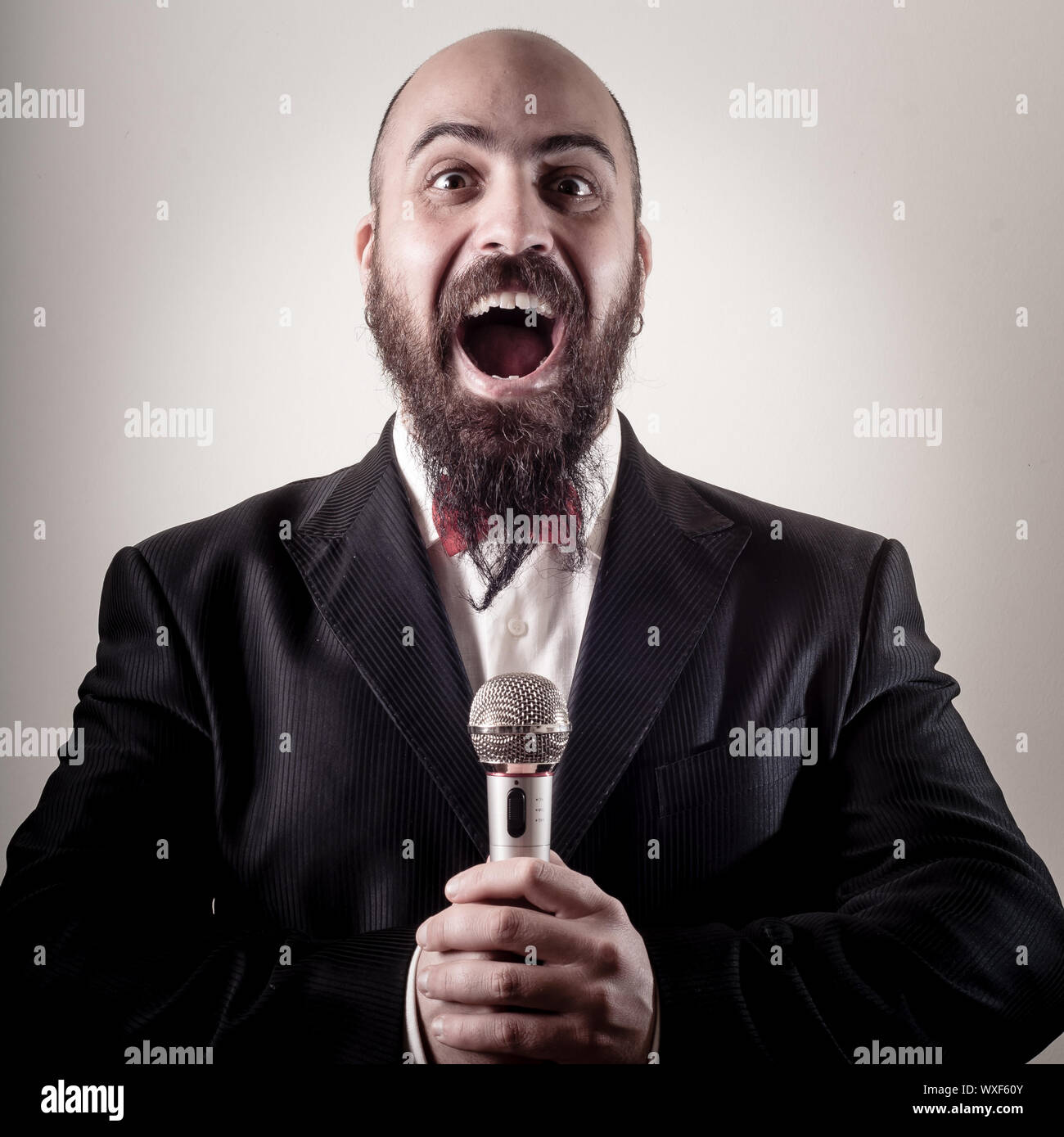 funny elegant singer bearded on vignetting background Stock Photo - Alamy