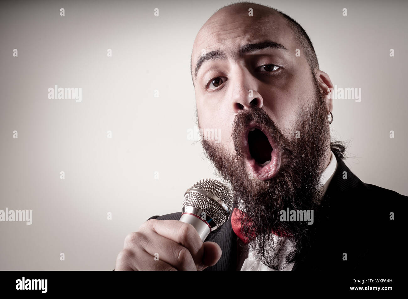 funny elegant singer bearded on vignetting background Stock Photo - Alamy