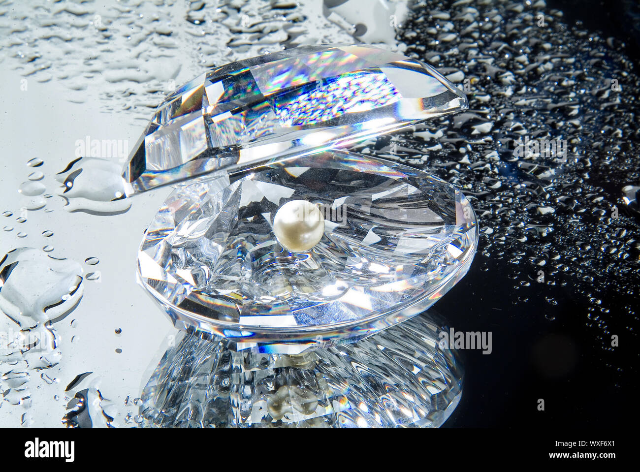 Crystal Shell And A Pearl On A Glass Stock Photo - Alamy