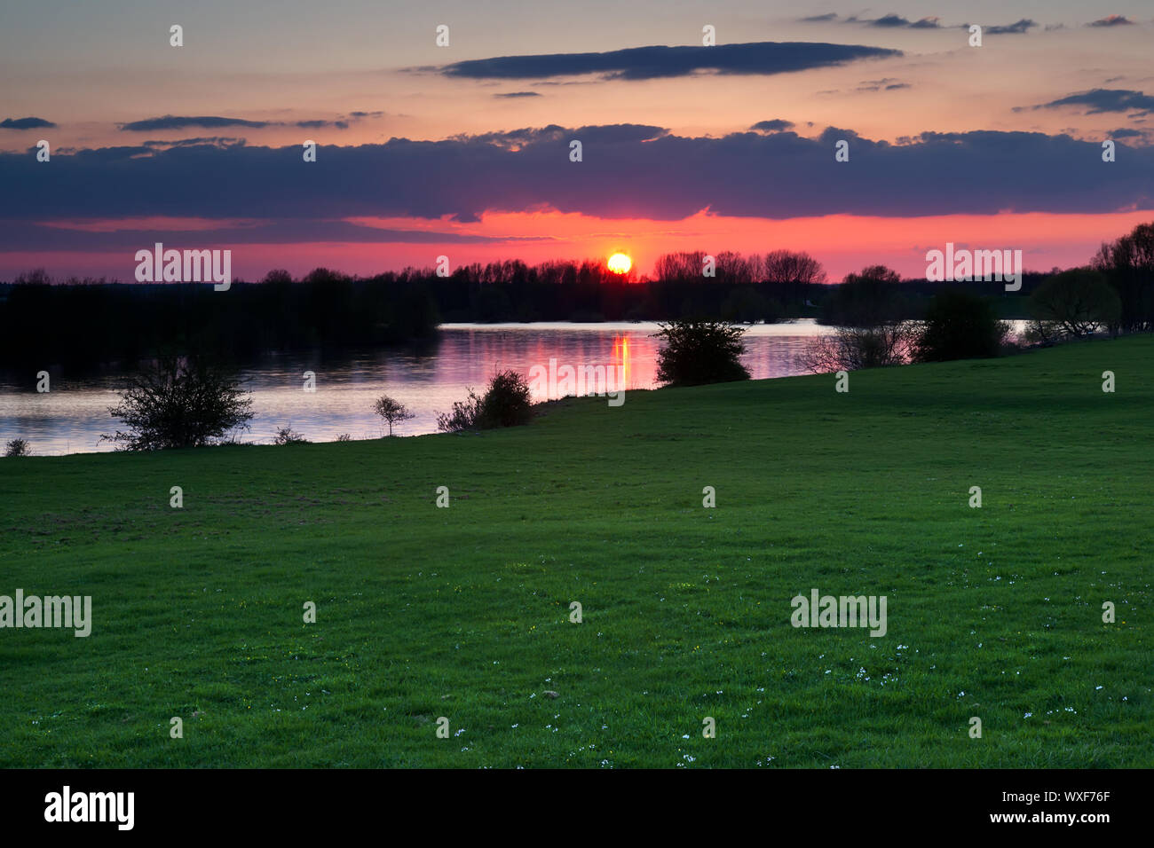 red dramatic sunset over river in Gelderland Stock Photo - Alamy
