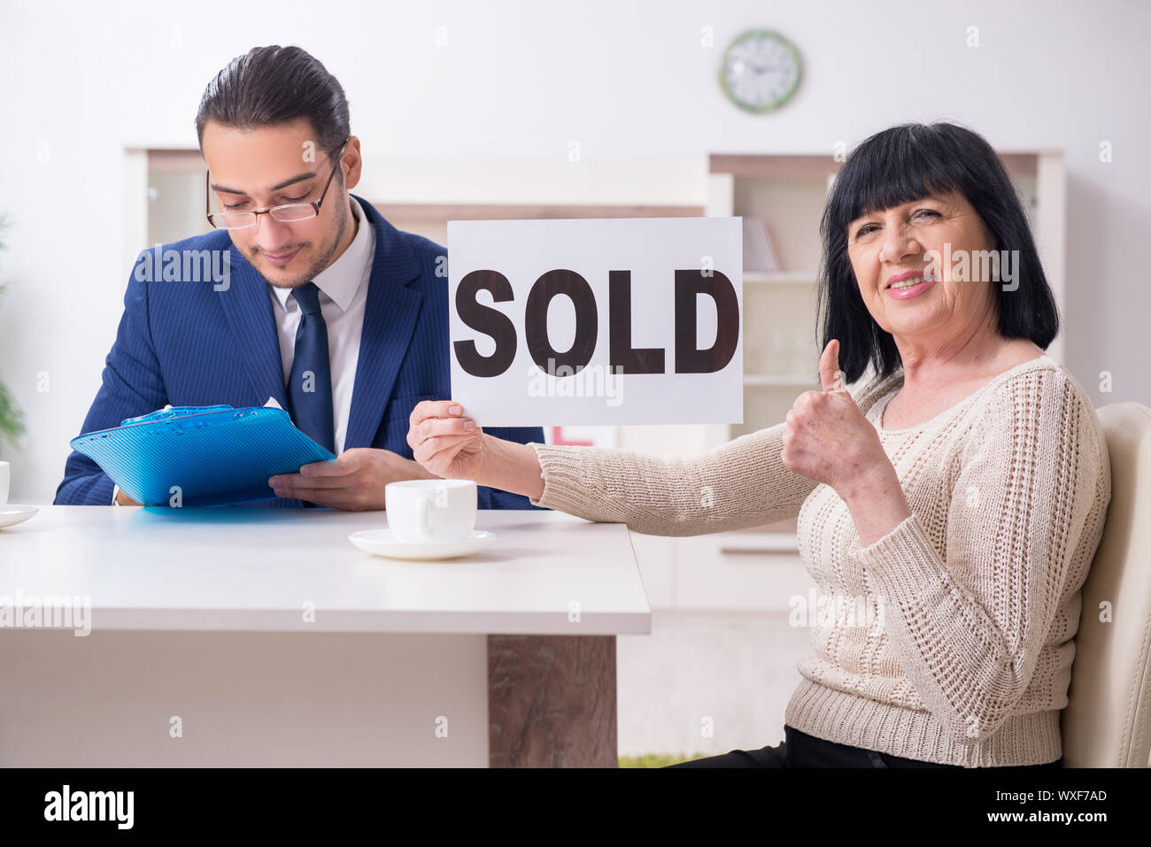 Male real estate agent and female client in the apartment Stock Photo ...