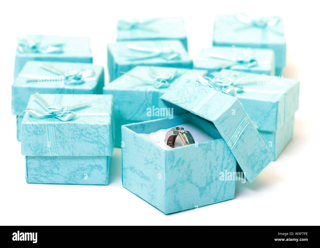 Cyan gift boxes with ring closeup on white background Stock Photo - Alamy